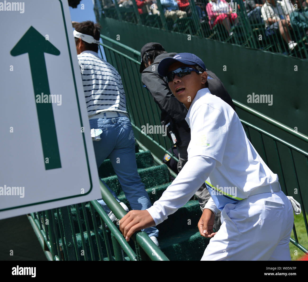 Fourteeen year old Andy Zhang of China heads up the stairs to the ...