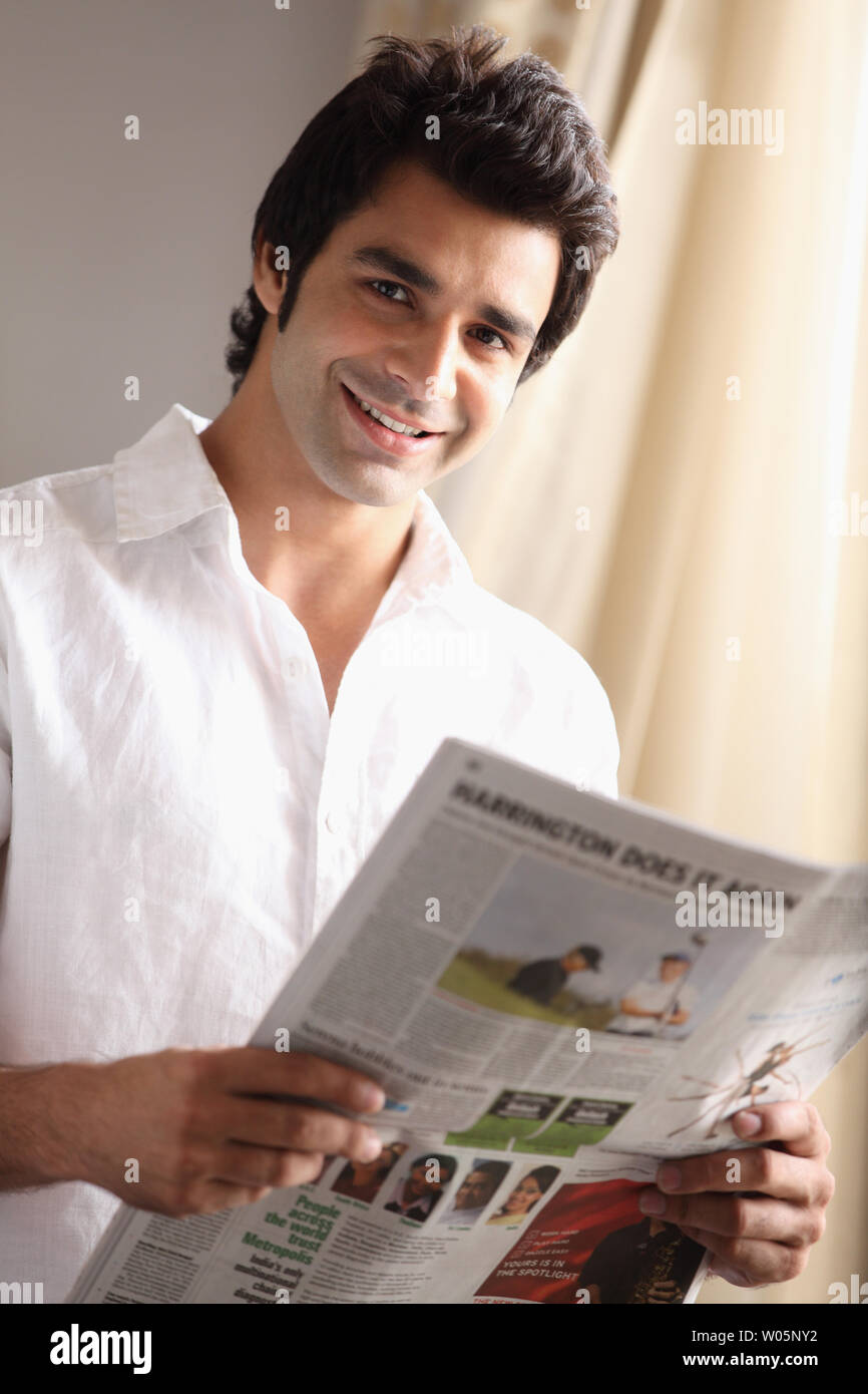 Portrait of a man reading a newspaper Stock Photo - Alamy