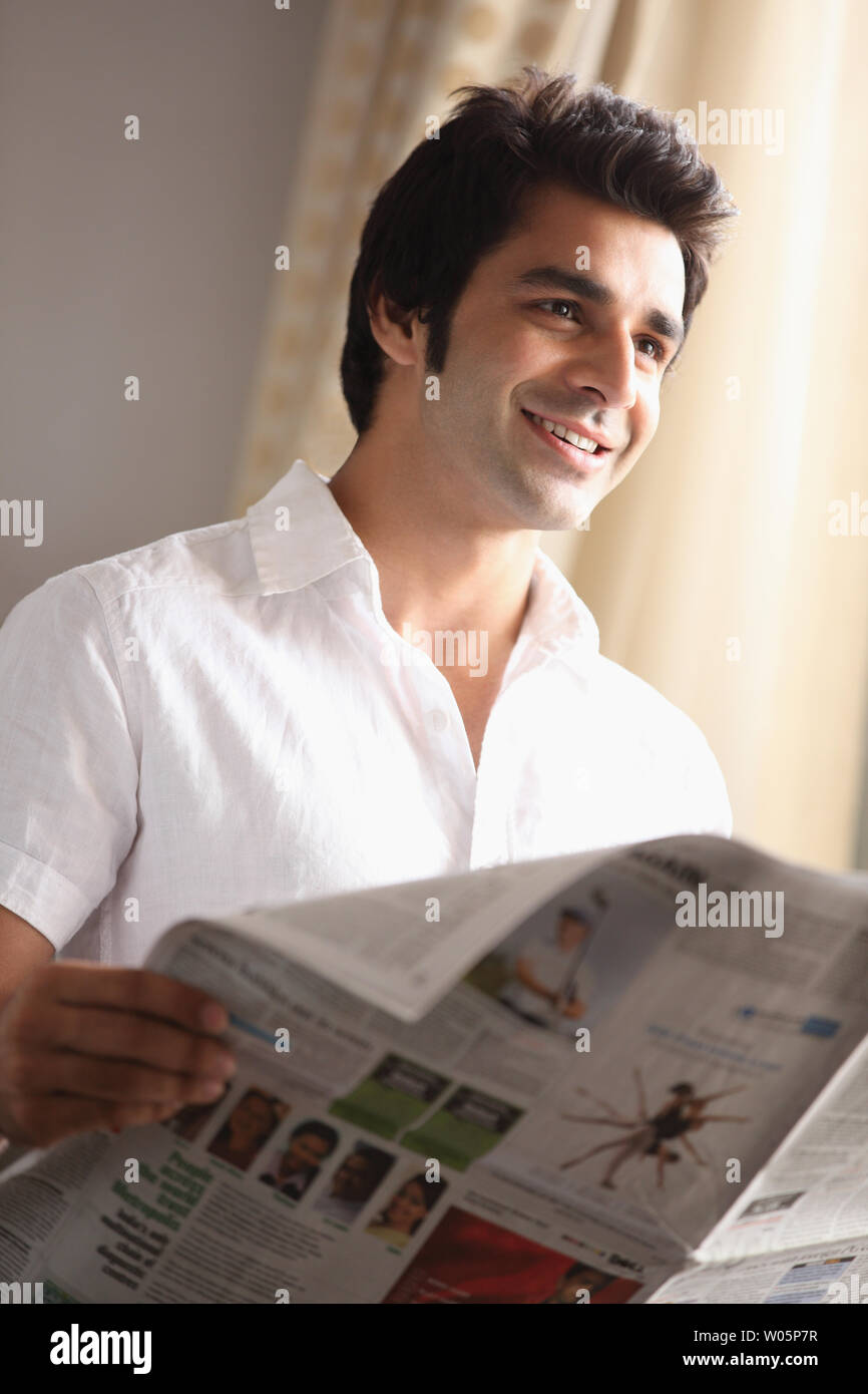 Indian house man reading paper hi-res stock photography and images - Alamy