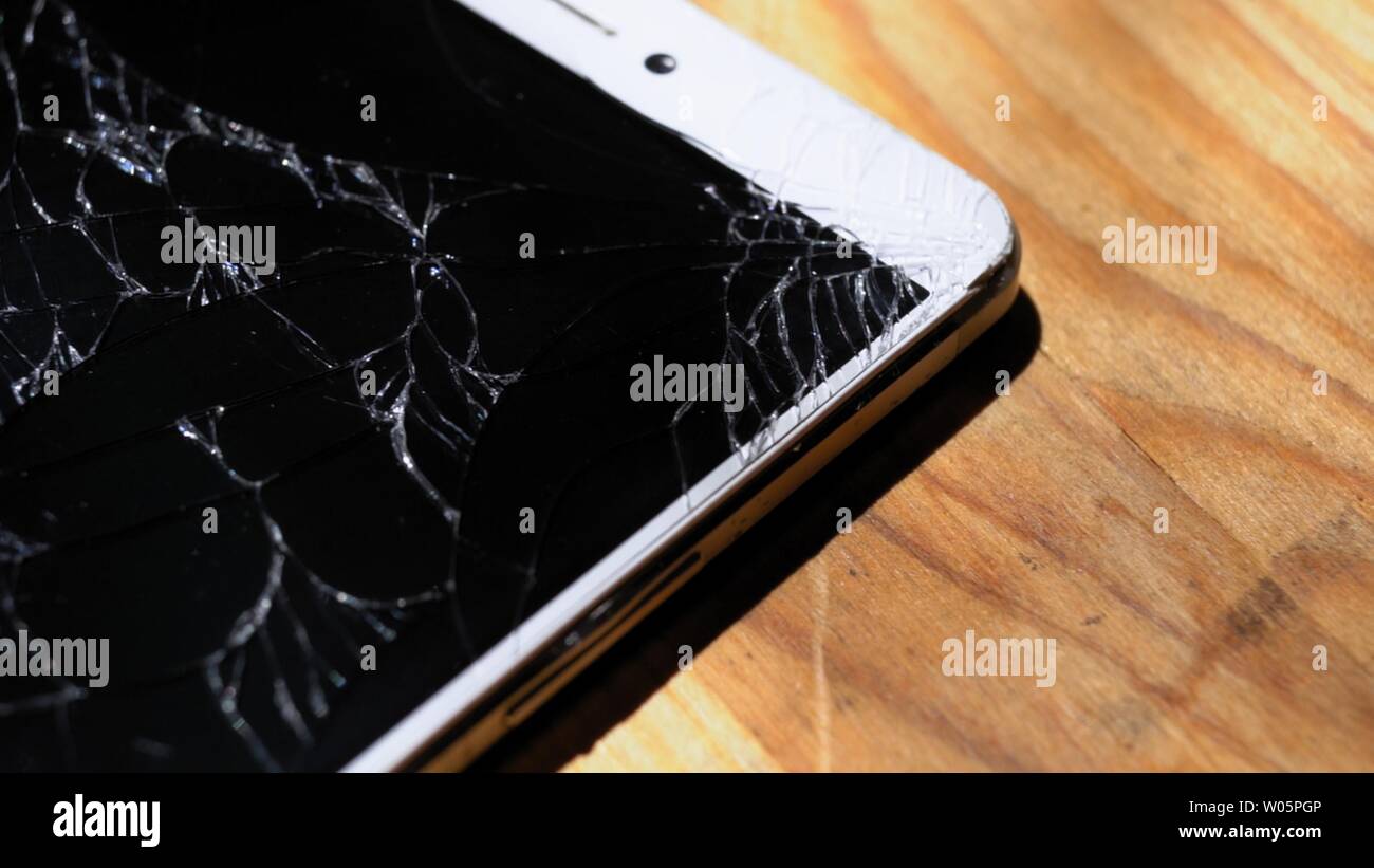 Xiaomi MI Max smartphone with broken screen matrix lies on wooden table ...