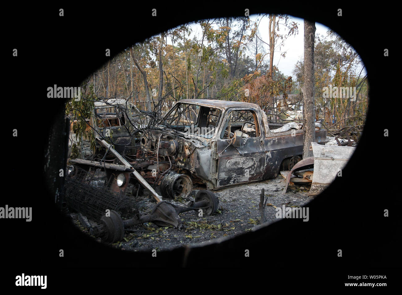 The burned remains of vehicles sit destroyed by the Valley Fire in ...
