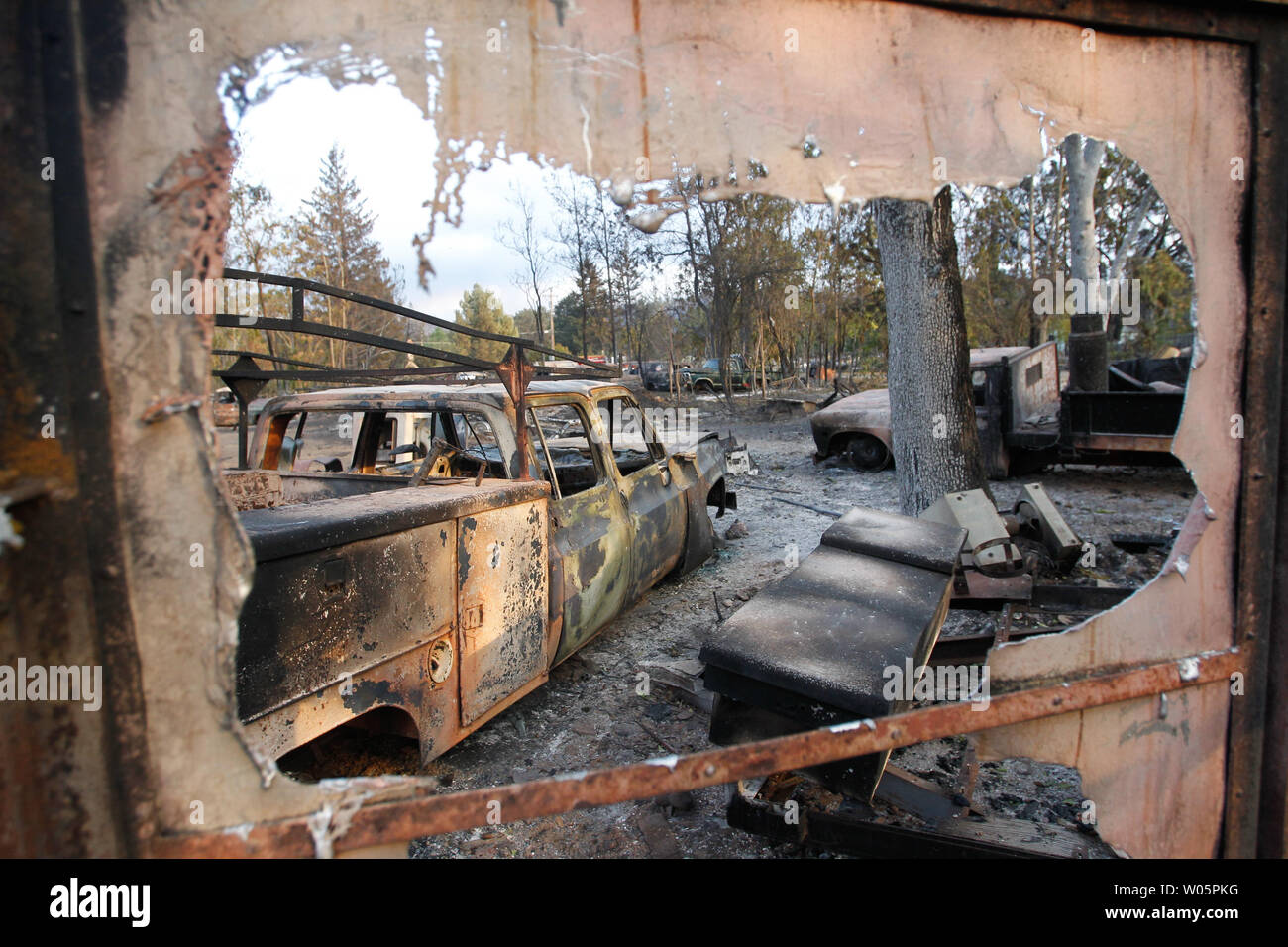 The burned remains of vehicles sit destroyed by the Valley Fire in ...
