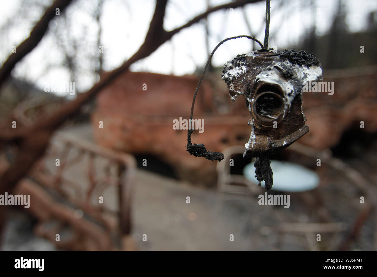 A scorched lantern hangs over the remains of Harbin Hot Springs ...