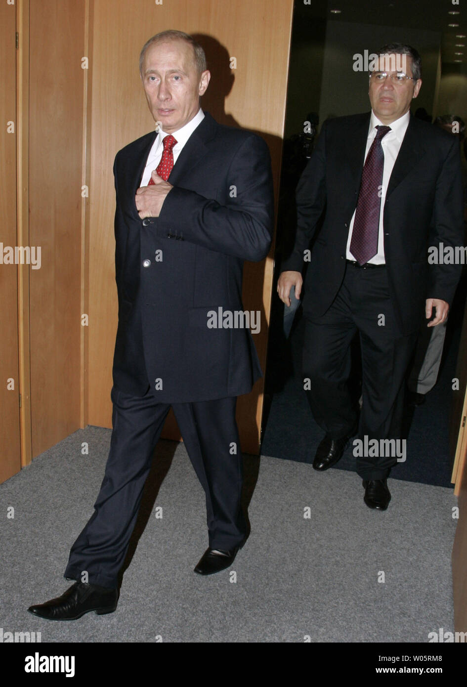 Russian President Vladimir Putin walks into a meeting with journalists ...