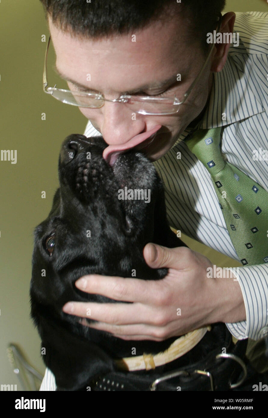 A journalist kisses Koni, Russian President Vladimir Putin's labrador ...
