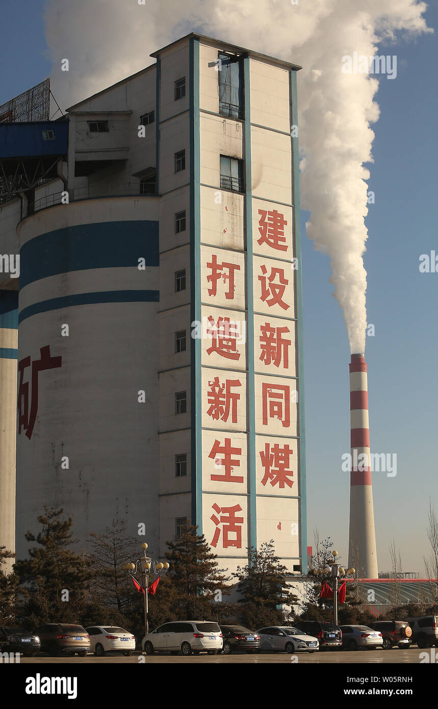 Smoke billows from a coal-powered electric power plant and industrial ...