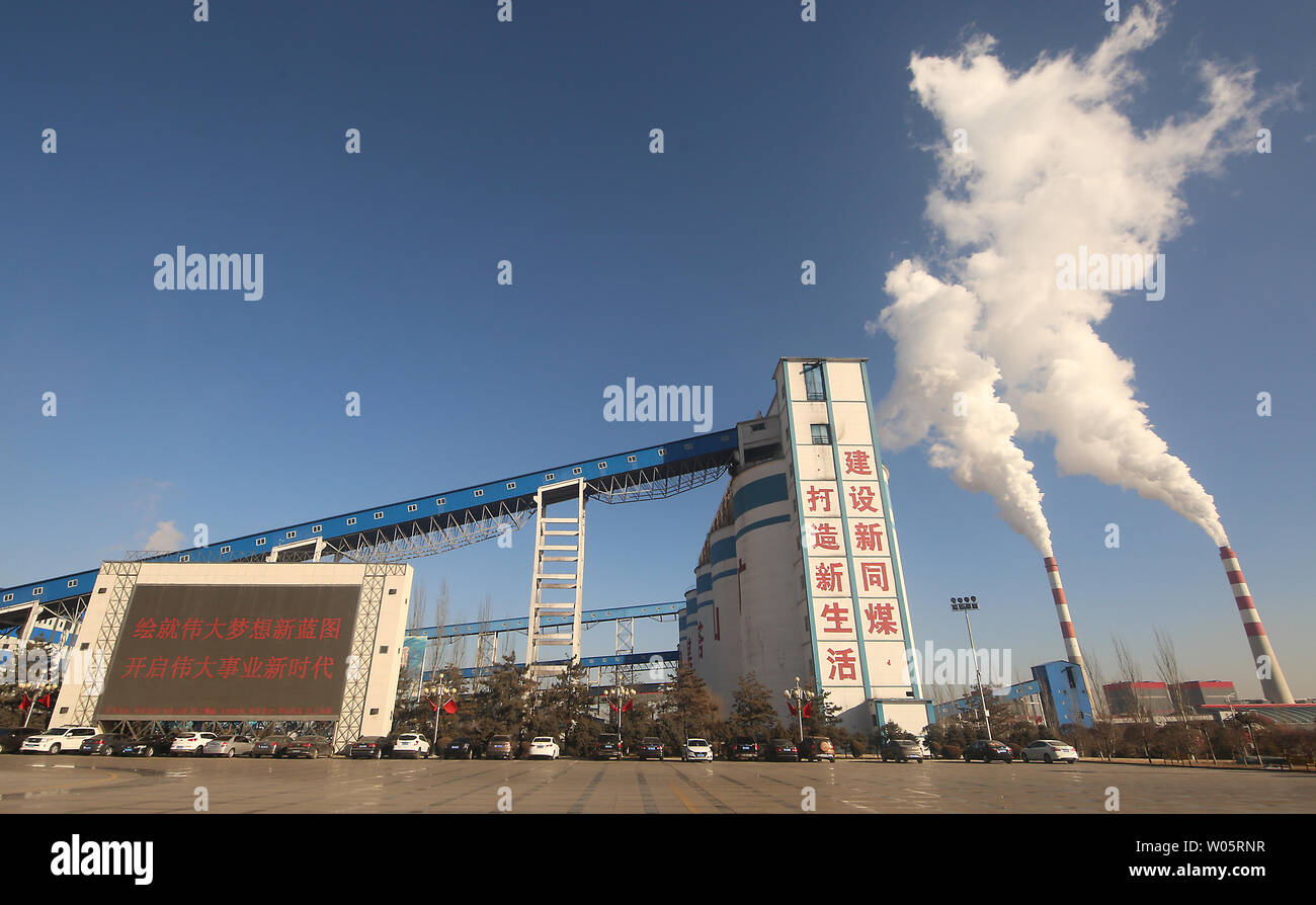 Smoke billows from a coal-powered electric power plant and industrial ...