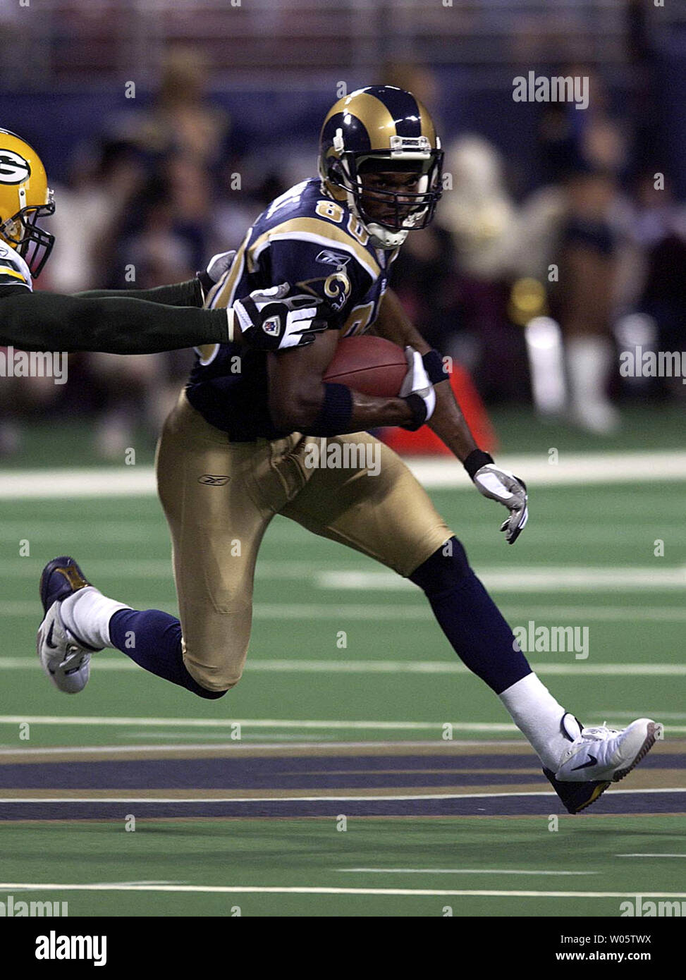St. Louis Rams receiver Isaac Bruce rushes after a pass completion ...