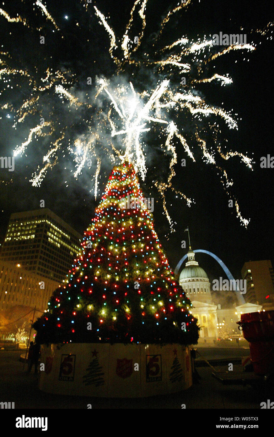 The Christmas tree is lit as fireworks light the nighttime sky as the ...