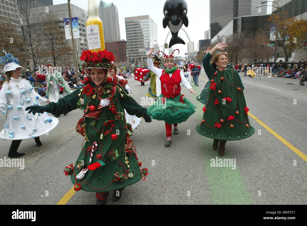 Parade participants dressed up as Christmas Trees make their way down ...