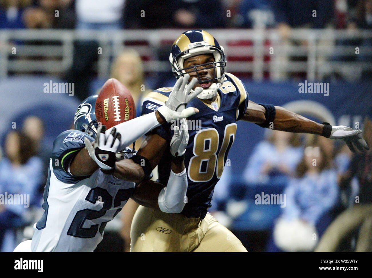St. Louis Rams Isaac Bruce (R) battles Seattle Seahawks Damien Robinson ...