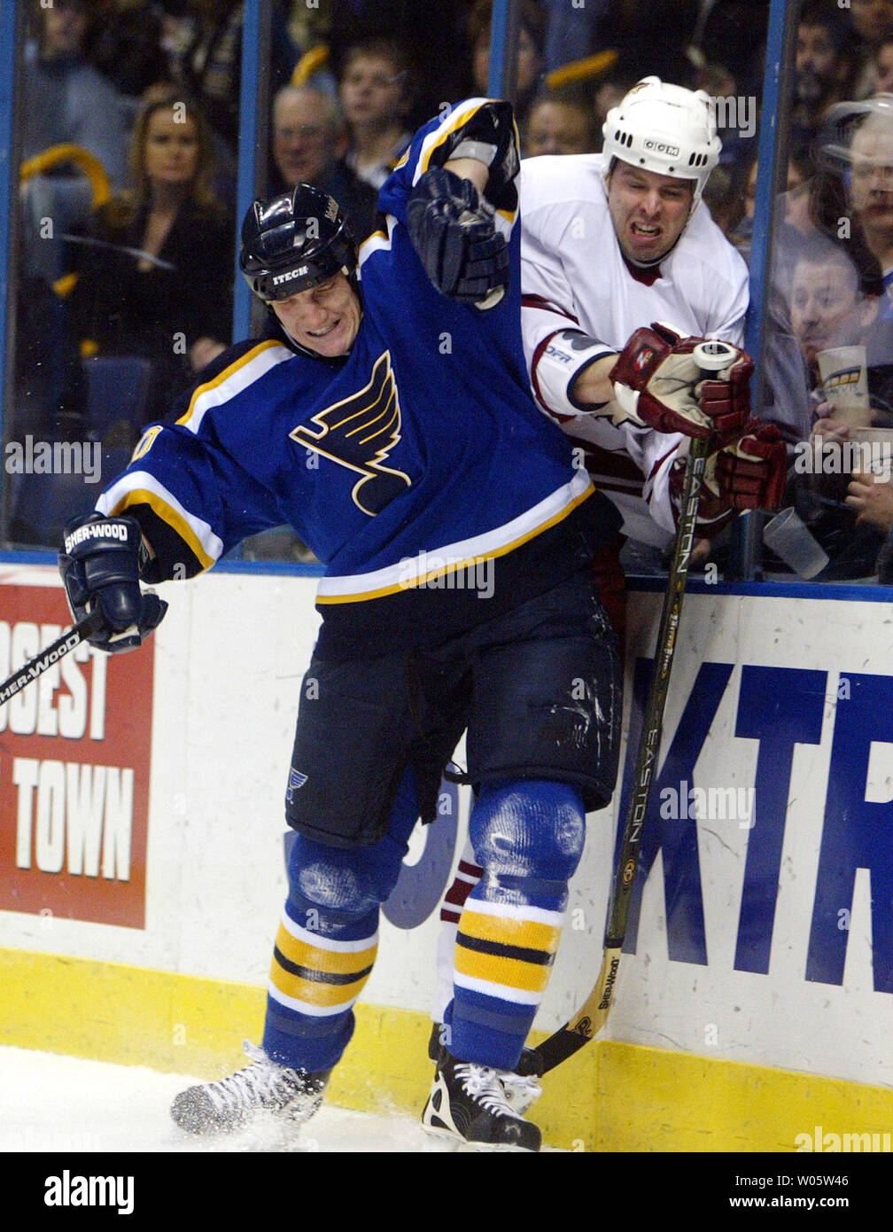 St. Louis Blues' Steve McLaren (L) puts Phoenix Coyotes' Cale Hulse ...