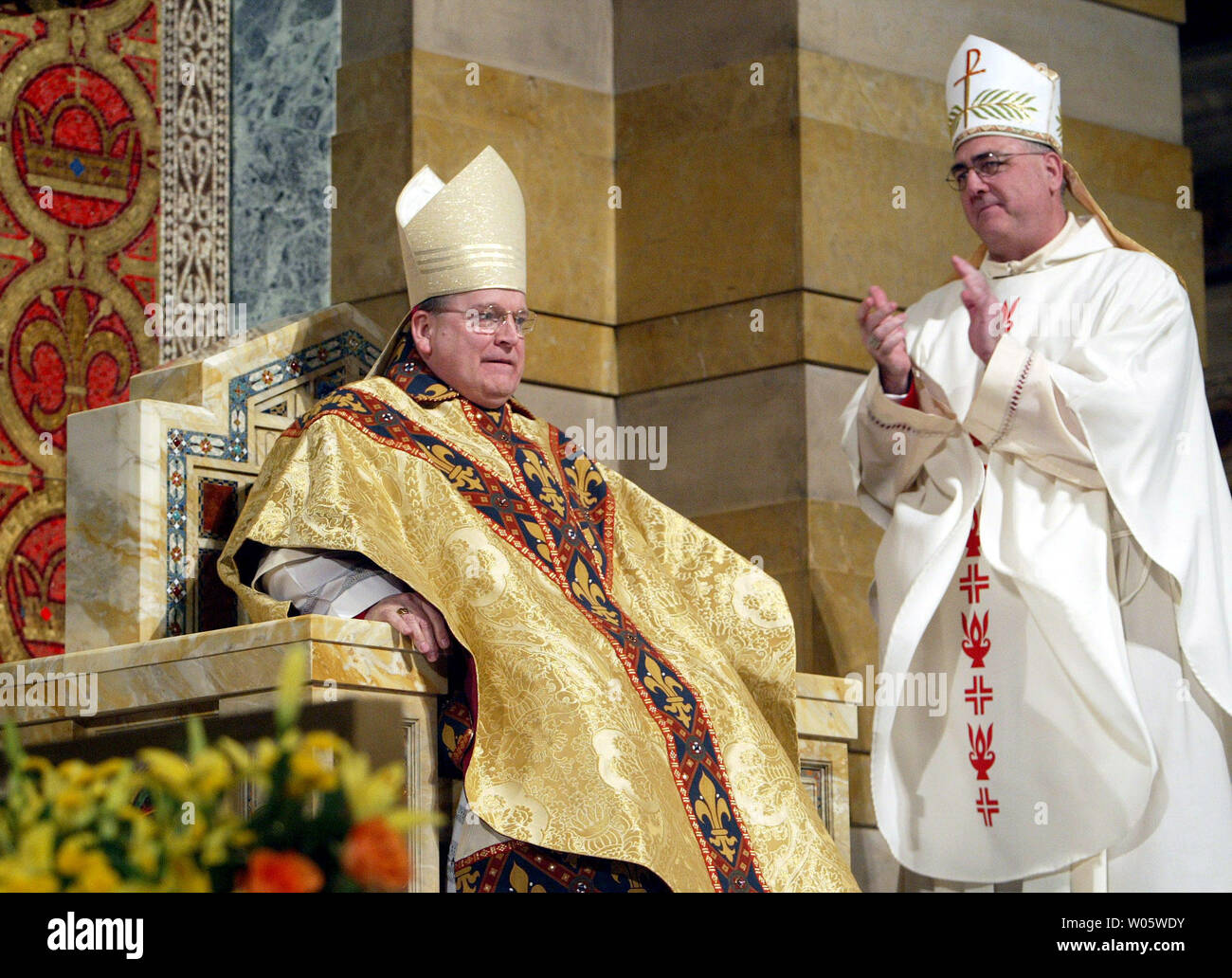 The new Archbishop of St. Louis, Raymond Burke, is appaluded by the ...