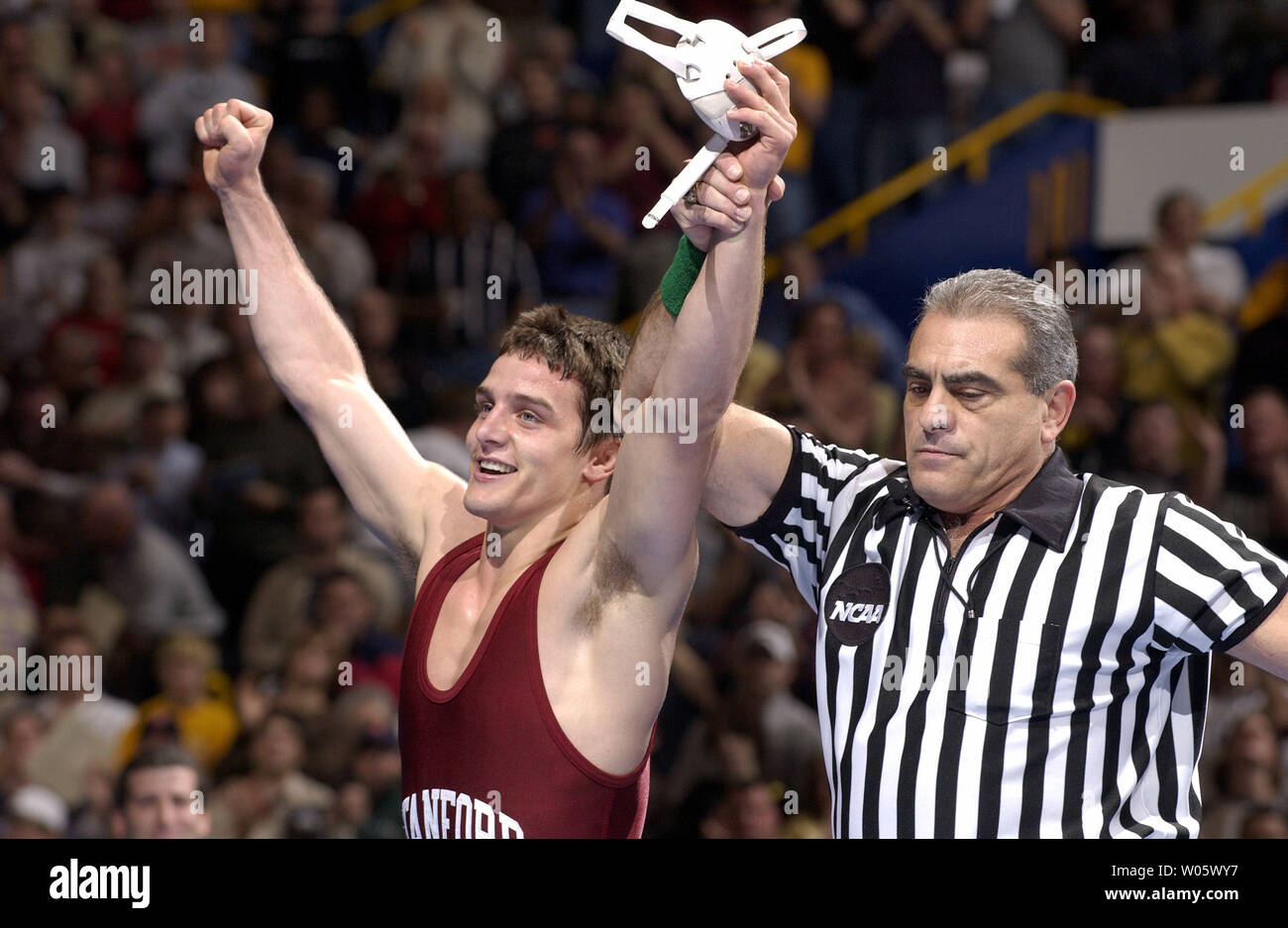 Matt Gentry of Stanford gets his arm raised by referee Fred Ambrose ...