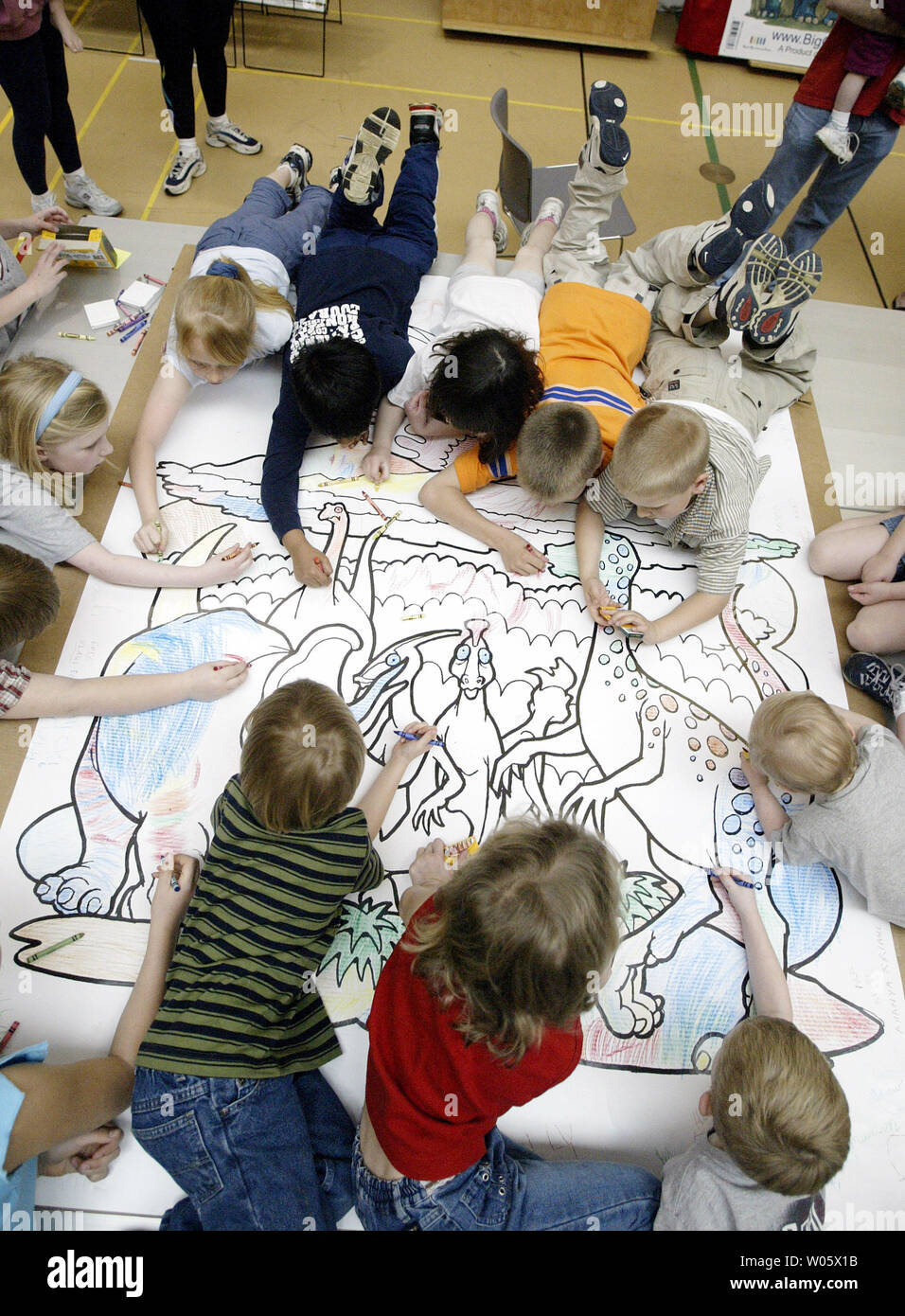 Children lay across a table as they color in the World's Largest ...