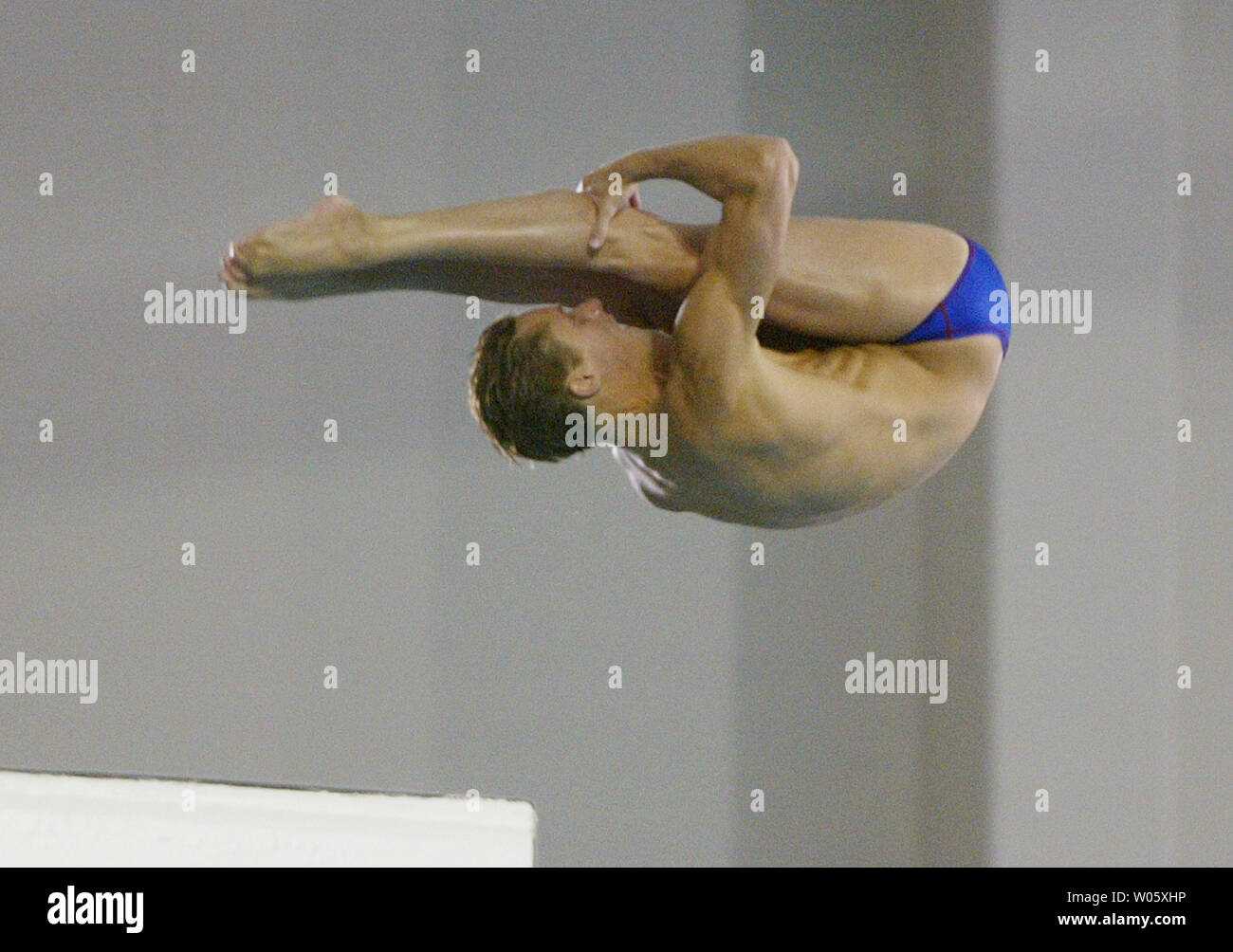 Diver Steven Segerlin of Webster, NY touches his chin to his knees as ...
