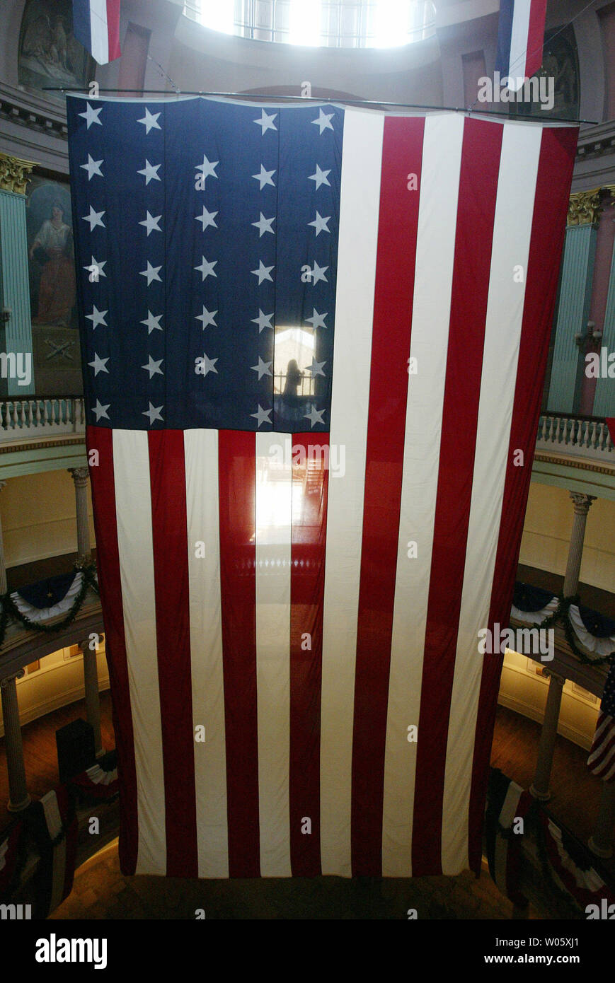 A tourist checks out the oversized Garrison Flag after it is hoisted to ...