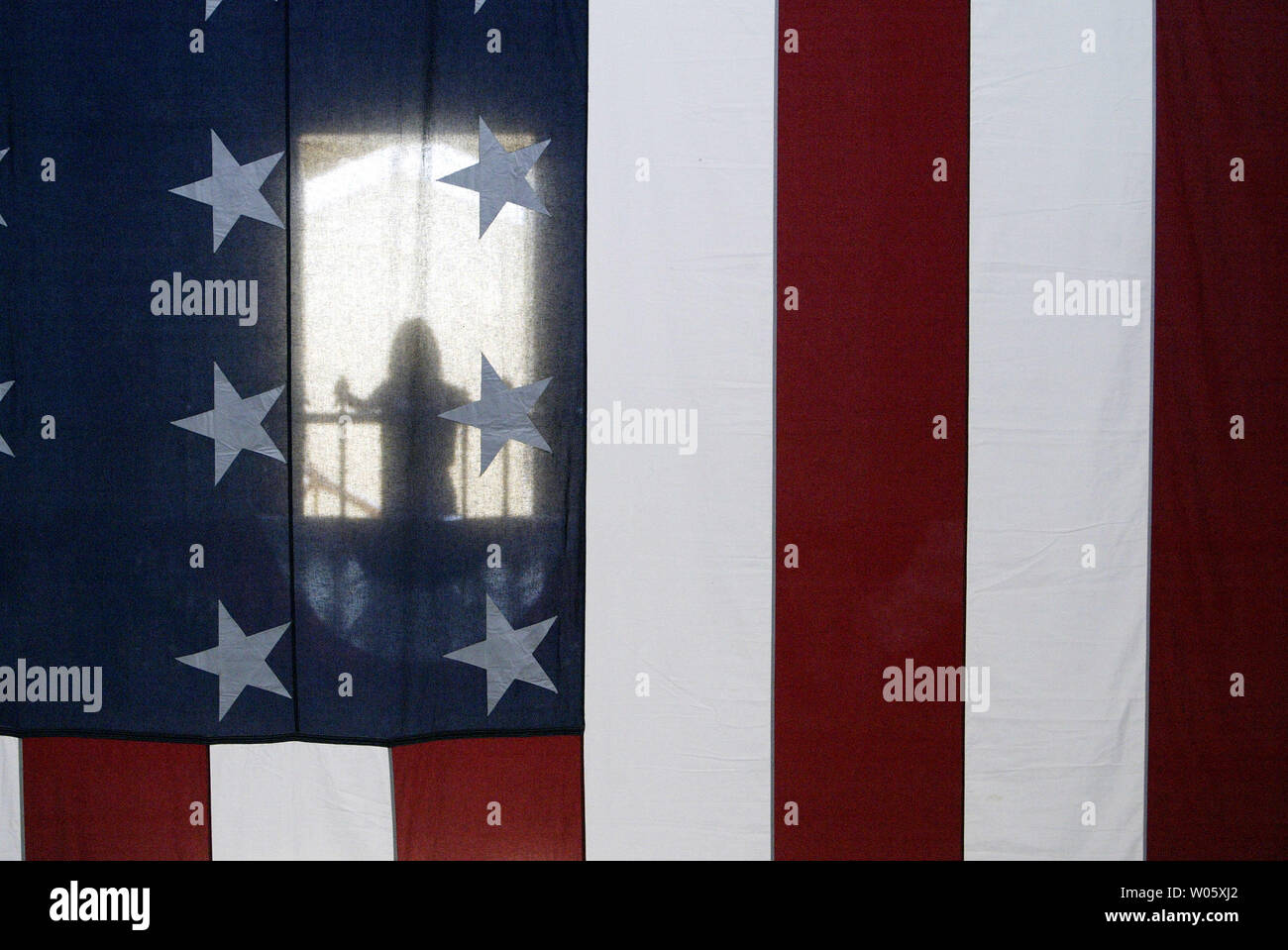 A tourist checks out the oversized Garrison Flag after it is hoisted to ...