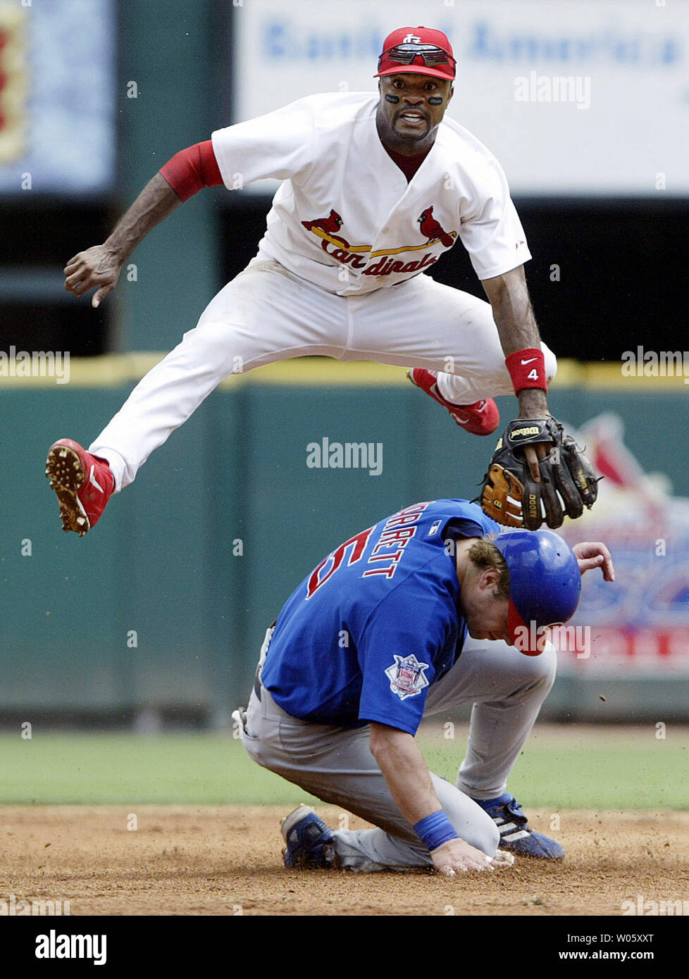 St. Louis Cardinals Tony Womack flies over Chicago Cubs Michael Barrett ...