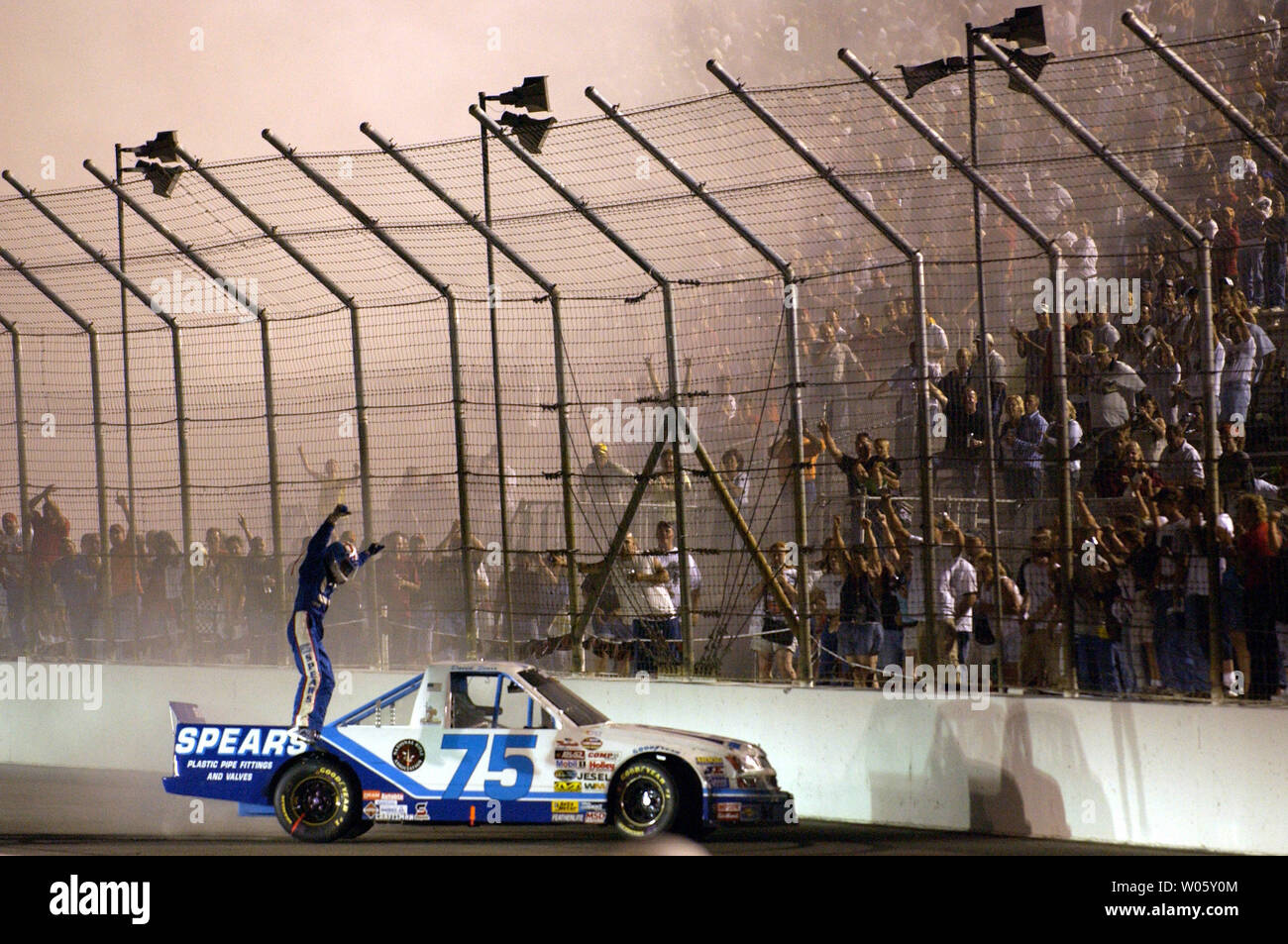 David Starr of Houston stands on his car as the crowds cheer after ...