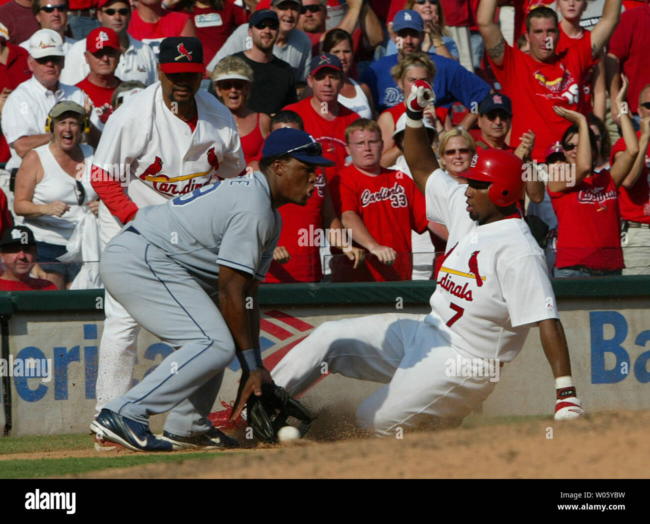 St. Louis Cardinals Hector Luna (R) slides safely into third base with ...