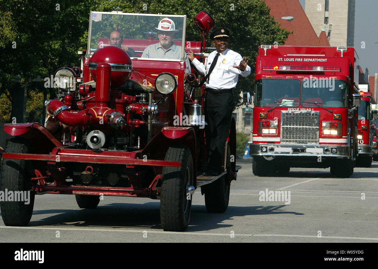 St. Louis Fire Chief Sherman George hangs from a 1927 Aherns Fox fire ...