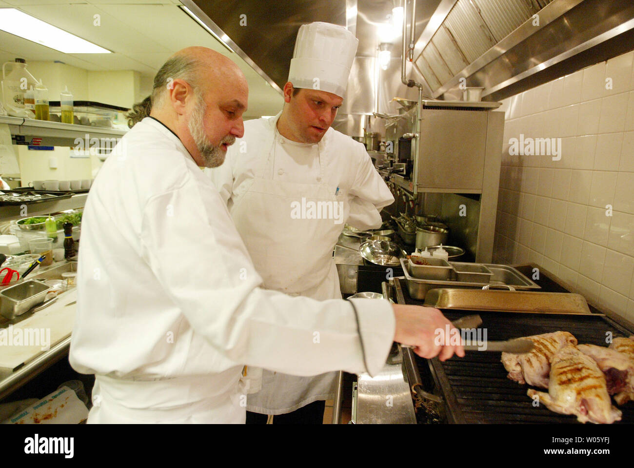 Famed chef and restaurateur Larry Forgione (L) shows executive chef ...