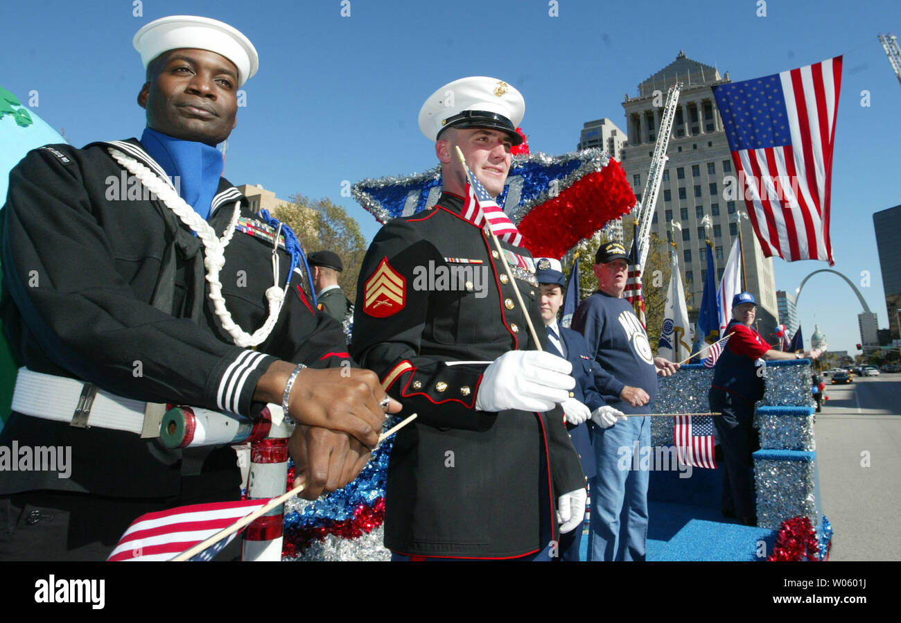 Members of various armed services wave small American flags from the ...