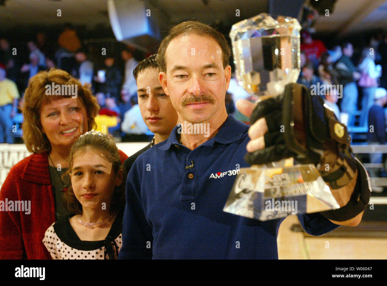 Professional Bowlers Association member Rick Lawrence holds his trophy ...