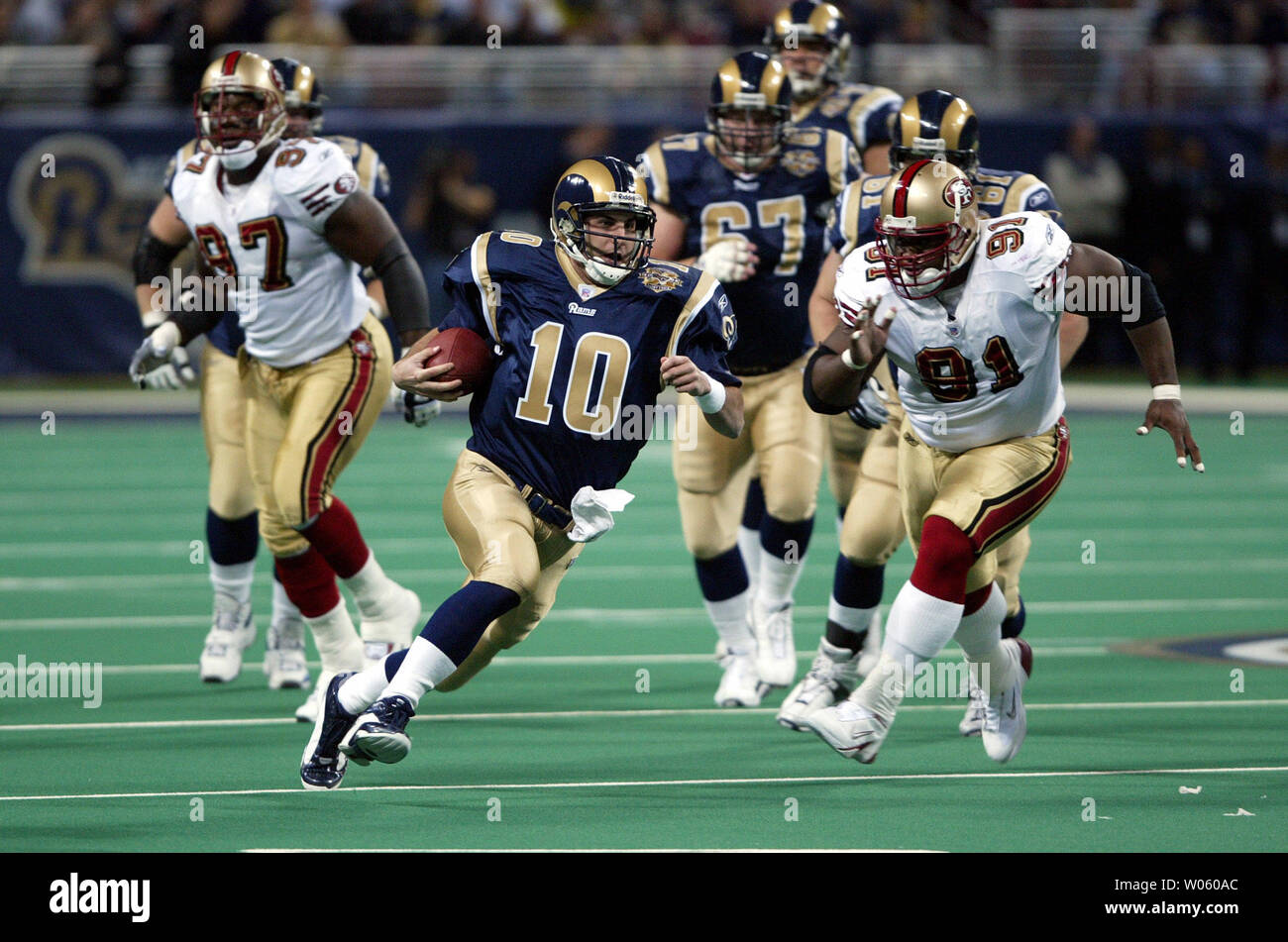 St. Louis Rams quarterback Marc Bulger runs for a nine-yard gain past ...