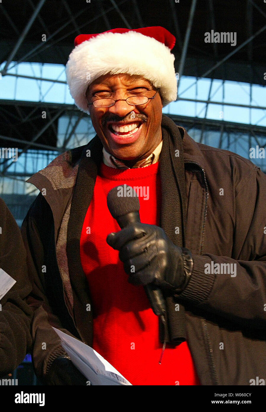 Singer/song writer Ralph Butler leads the crowd in the singing of a ...