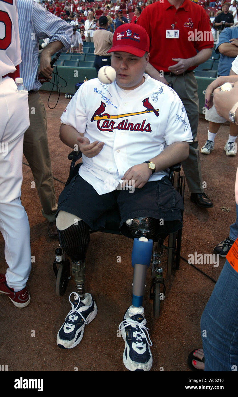 St. Louis Police officer Matt Browning tosses a baseball before ...