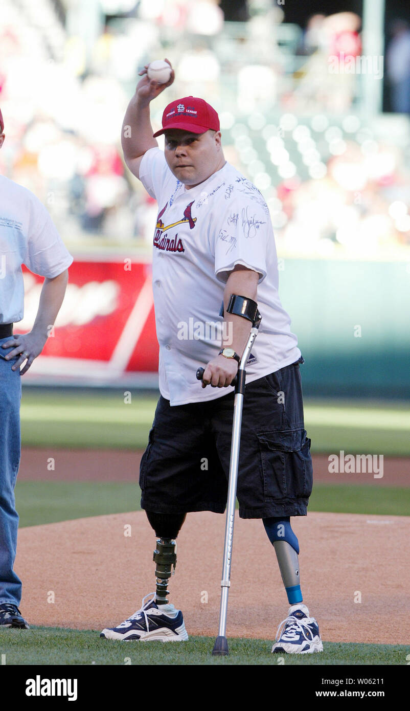 St. Louis Police officer Matt Browning rears back to throw out the ...