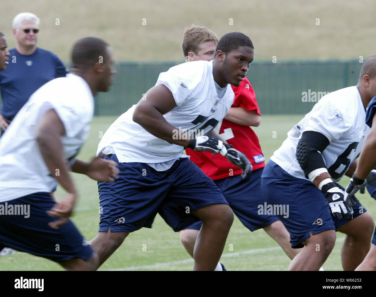 St. Louis Rams number one draft choice Alex Barron (C) protects his ...