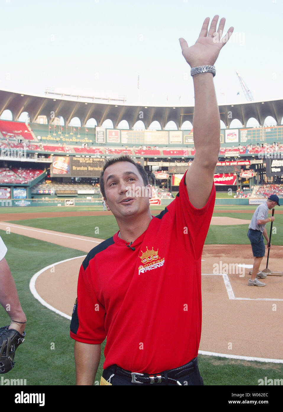 Top fuel driver Brandon Bernstein waves to the crowd as he is ...