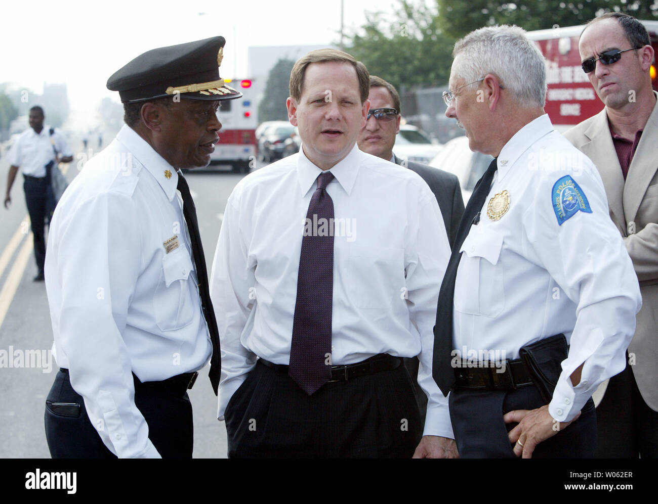 St. Louis Mayor Francis Slay (C) talks with St. Louis Fire Chief ...