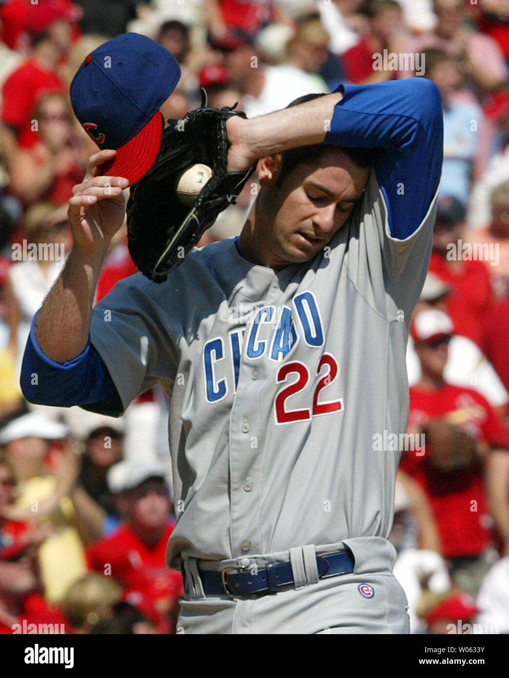 A disappointed Chicago Cubs pitcher Mark Prior wipes his face on his ...
