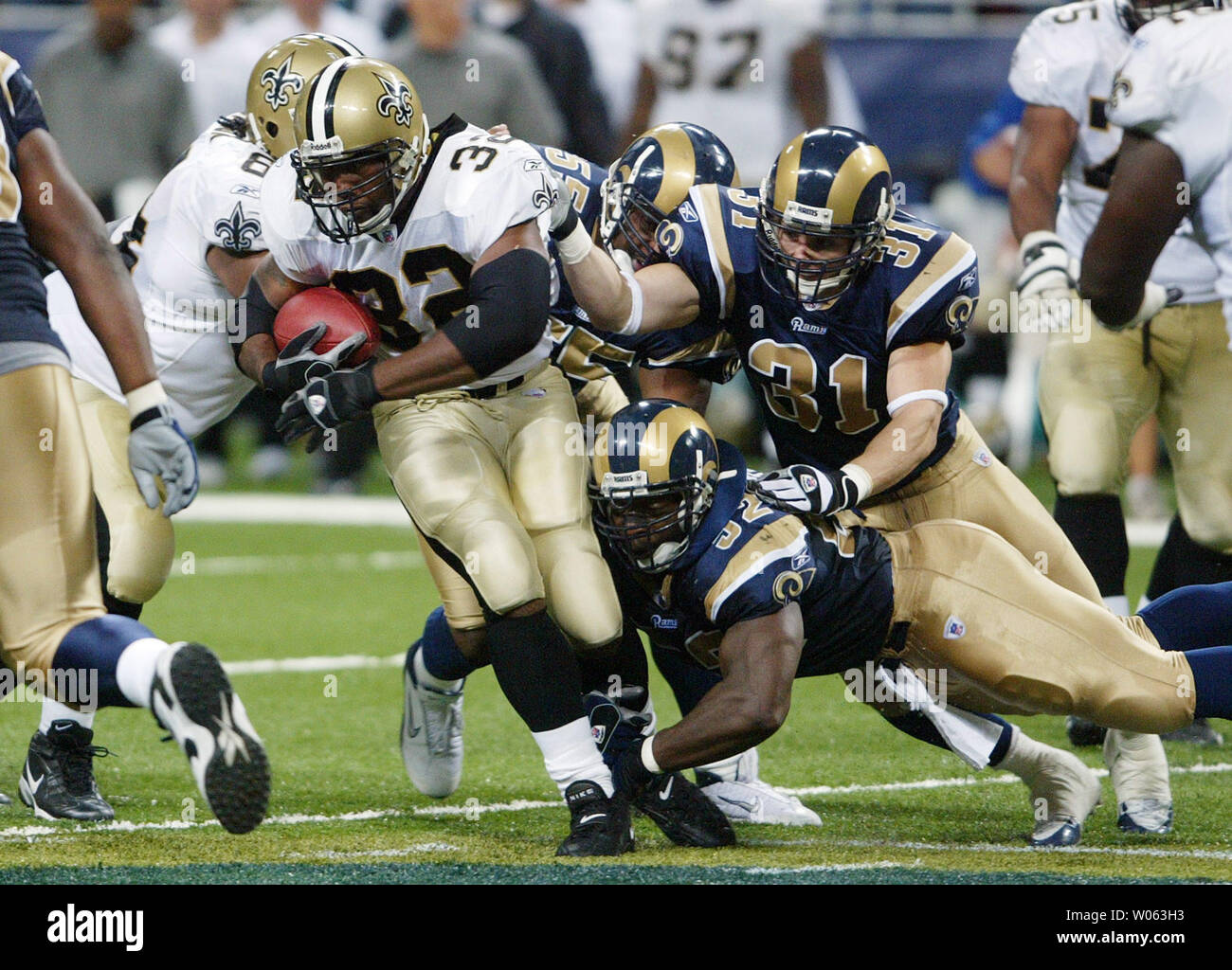 New Orleans Saints Antowain Smith (32) has his progress slowed by St ...