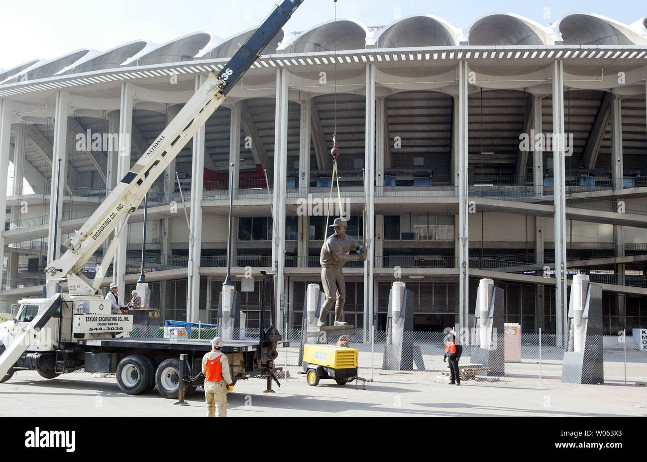 Construction workers slowly move the Stan Musial statue from its ...