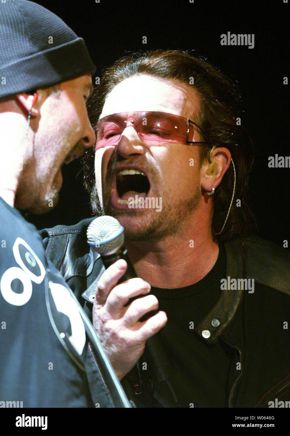 Bono of the rock group U-2 (R) sings with guitarist Edge during their ...