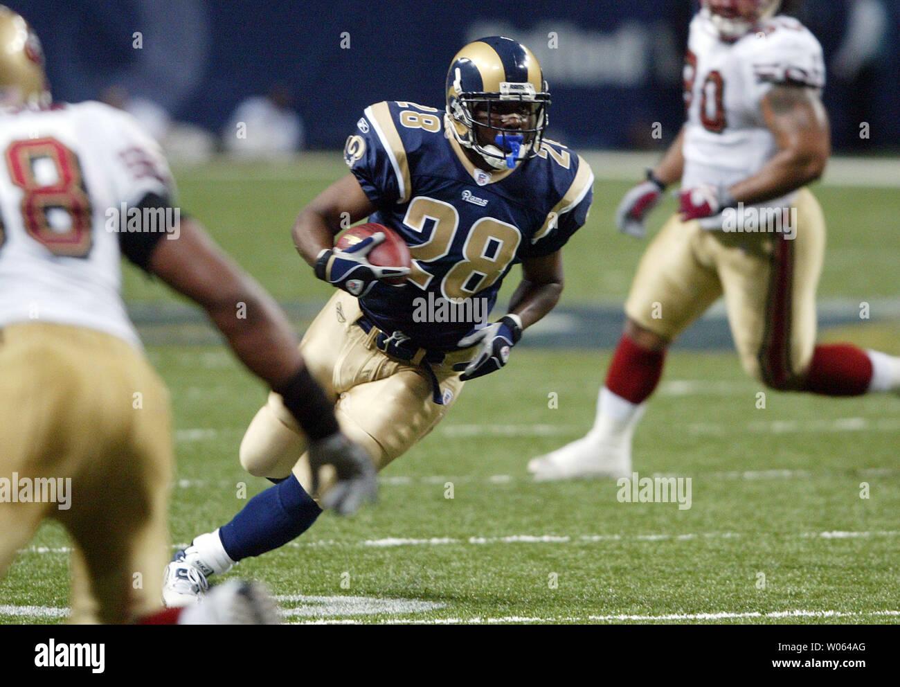 St. Louis Rams Marshall Faulk cuts through the San Francisco 49er's ...