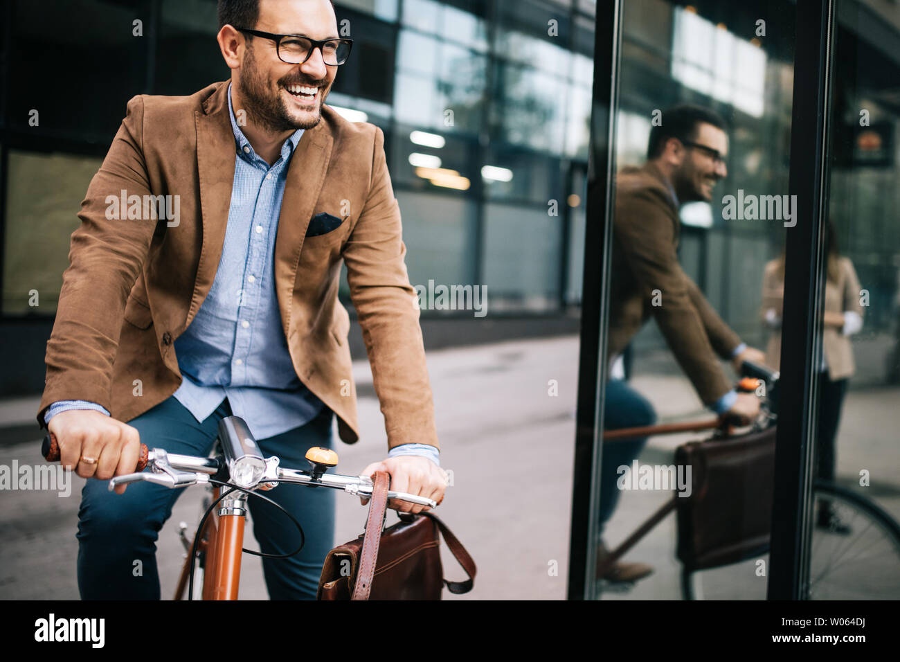 Happy businessman riding bicycle hi-res stock photography and images ...