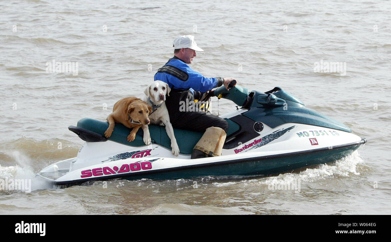Kevin Day takes his two dogs Jet Ski (R) and Brown Sugar for a ride on ...