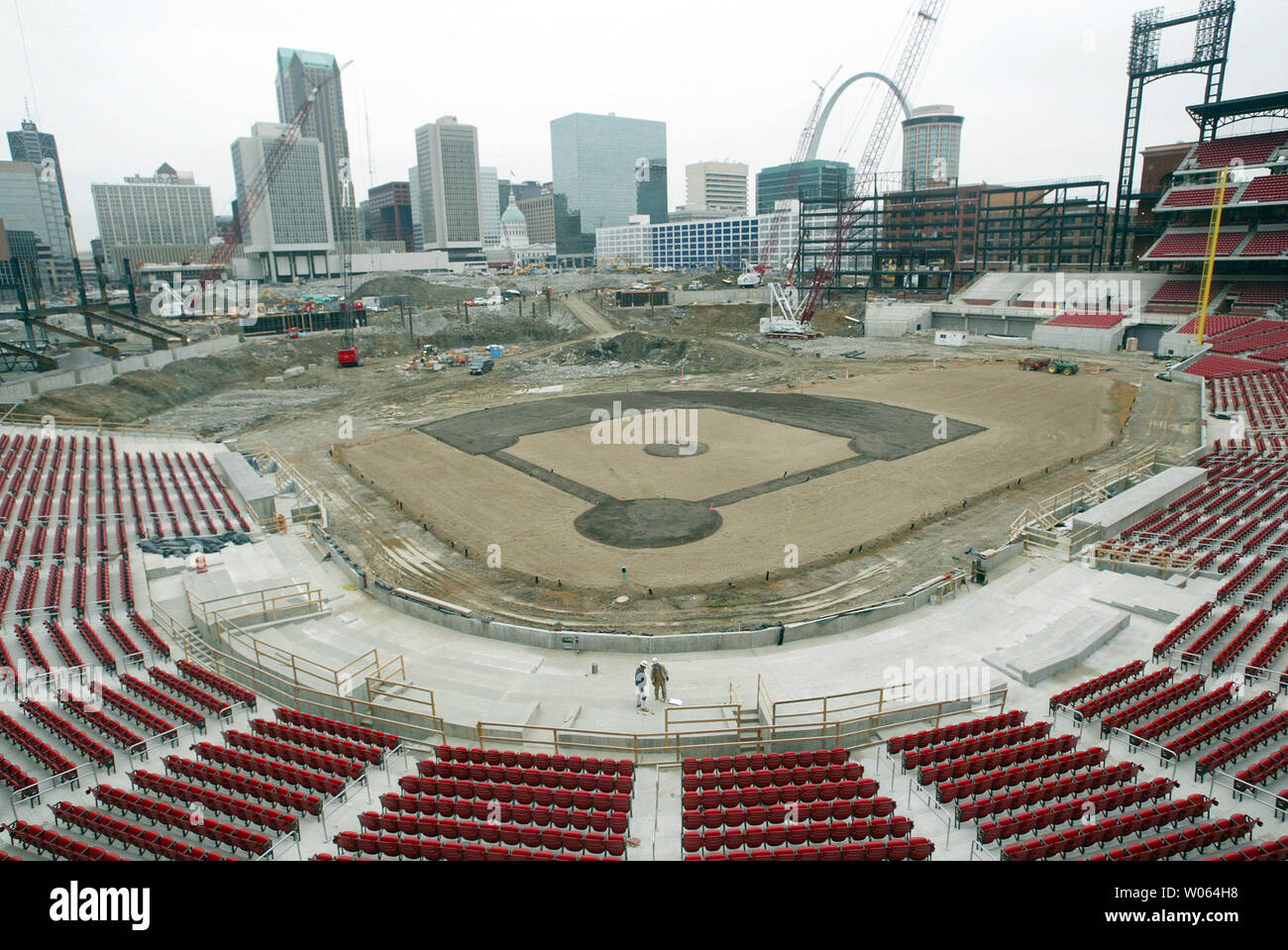 Construction workers take measurments for premium seating as the ...