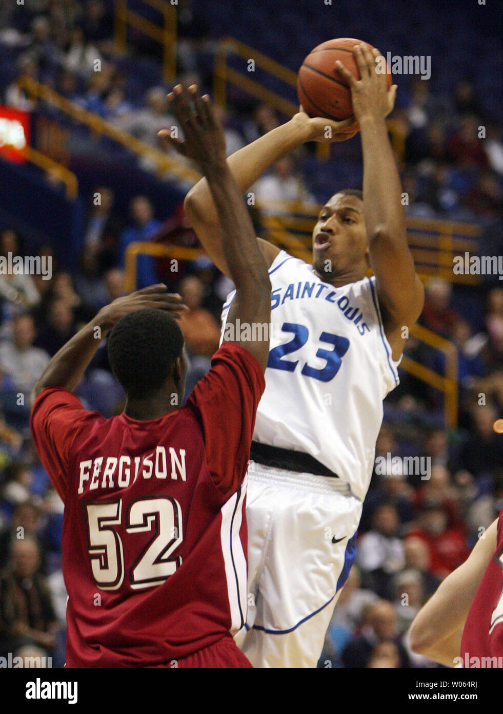 Saint Louis University's Justin Johnson (23) goes up and over Saint ...