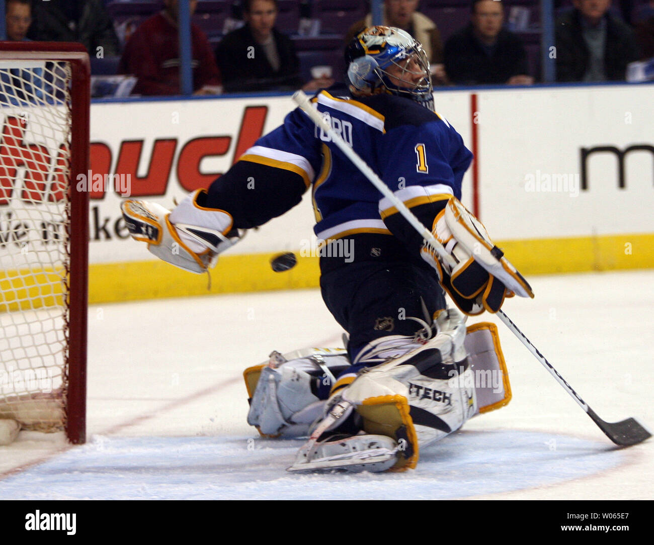 St. Louis Blues goaltender Curtis Sanford watches the puck go past him ...