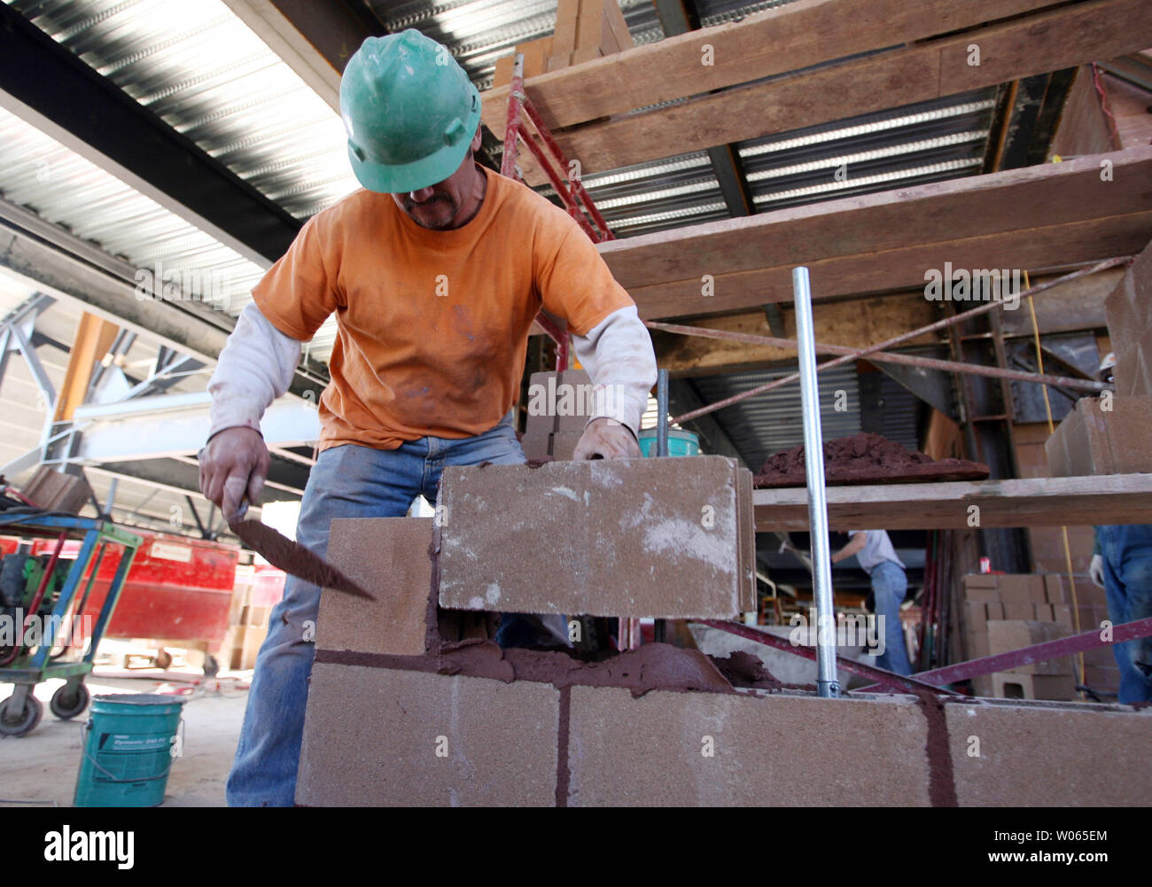 Bricklayer Gary Bedford installs blocks on a upper terrace stairwell at ...