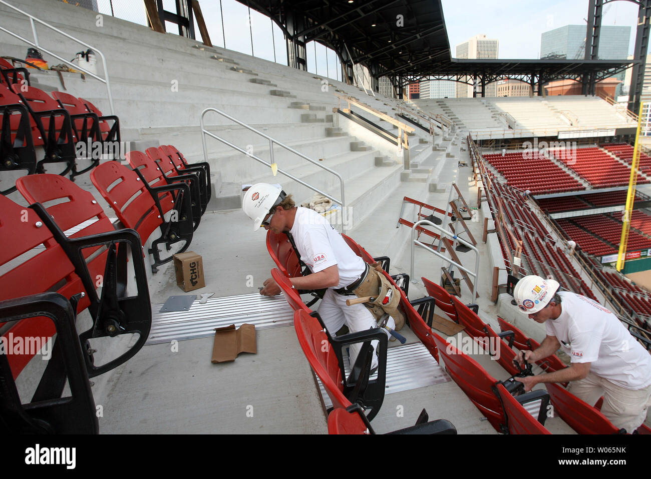 Workers Tim Casteel (L) and Lee Rowe install seating in the left field ...