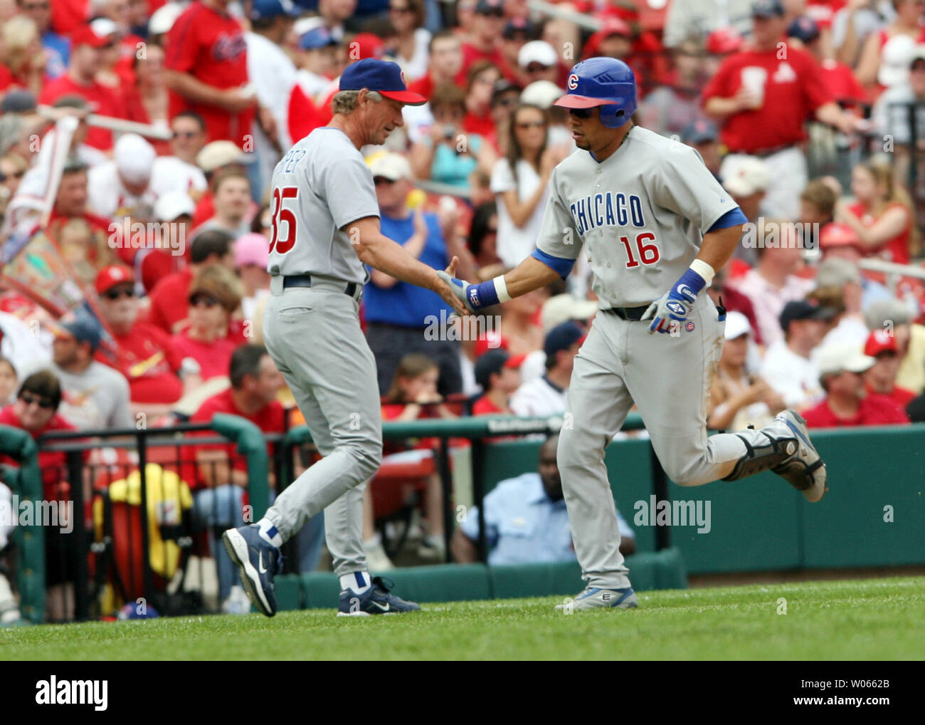 Chicago Cubs third base coach Chris Speier (L) congratulates Aramis ...