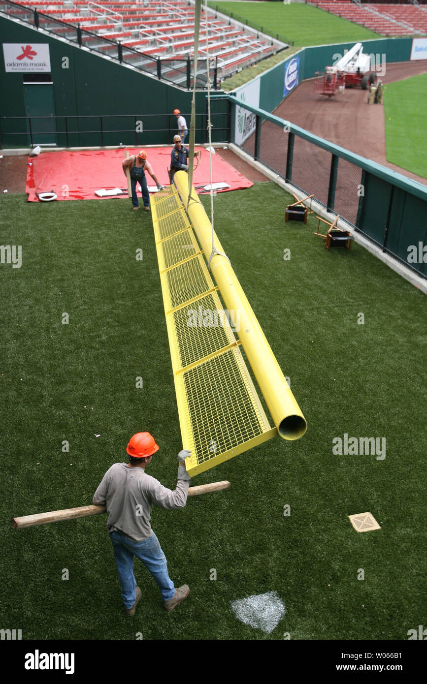 Iron workers use the visitors bullpen as a staging area as they place ...